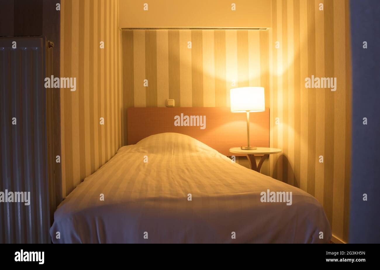 Simple hotel room, single bed Stock Photo - Alamy