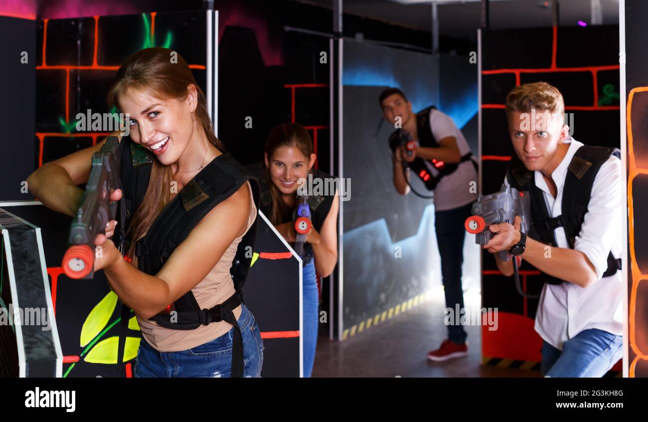 Young team playing laser tag game Stock Photo - Alamy