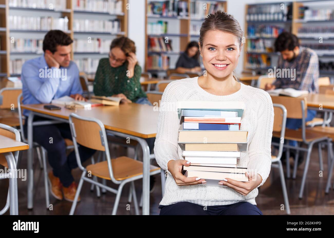Female student sitting in library Stock Photo - Alamy