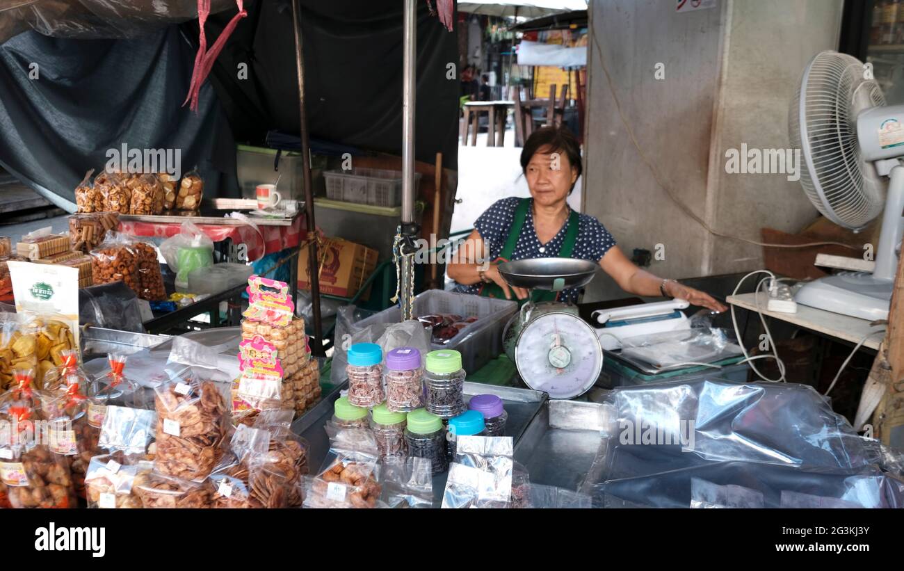 Middle aged Lady vendor selling cookies and candy and sweets on ...