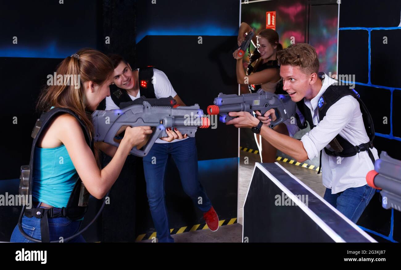 rivals guy and girl with laser guns Stock Photo - Alamy