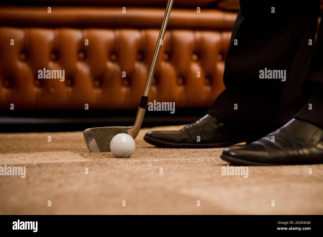 Man playing golf at office Stock Photo - Alamy
