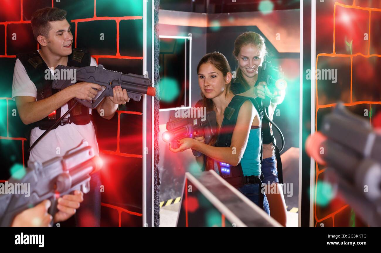 Glad Laser tag players playing in teams Stock Photo - Alamy