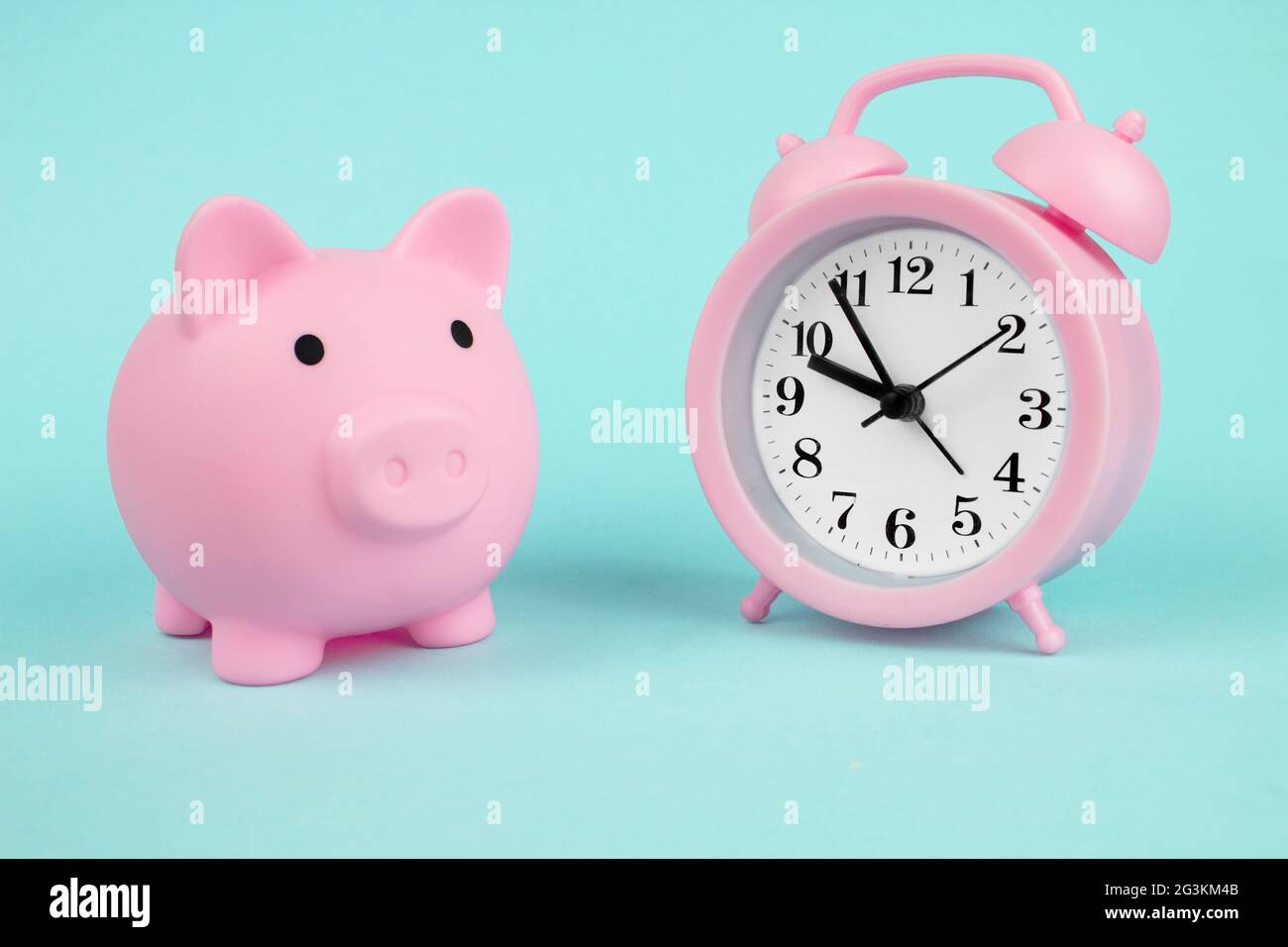 Pink piggy bank Piggy Bank and clock on blue background. Money saving ...