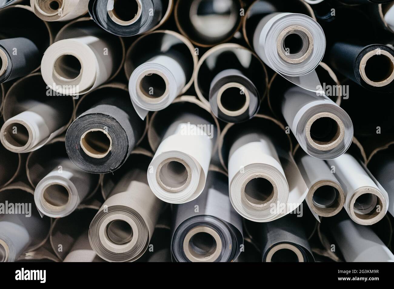 Closeup of rolls of textile and fabric for roller blinds in a factory ...