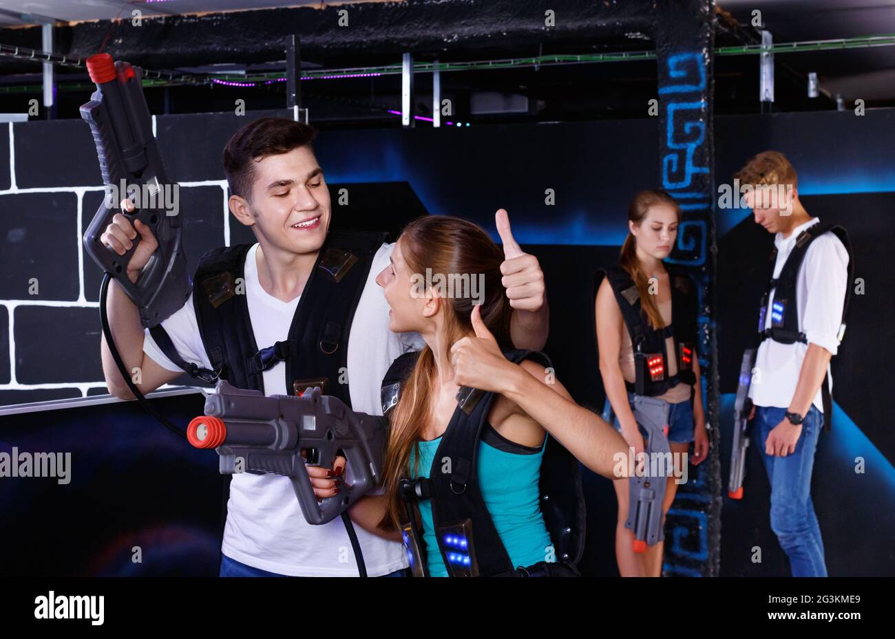 Girl and guy with laser pistols happy with their victory over opposing ...