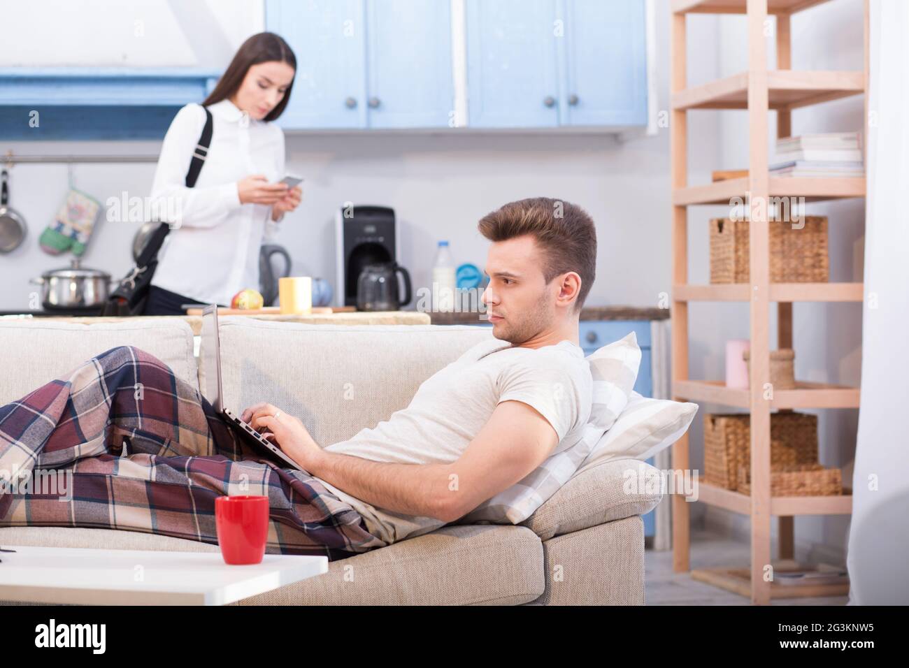 Young woman gooing to work while her husband staying and working at ...