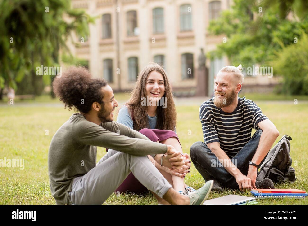 Happy laughing students at University garden Stock Photo - Alamy