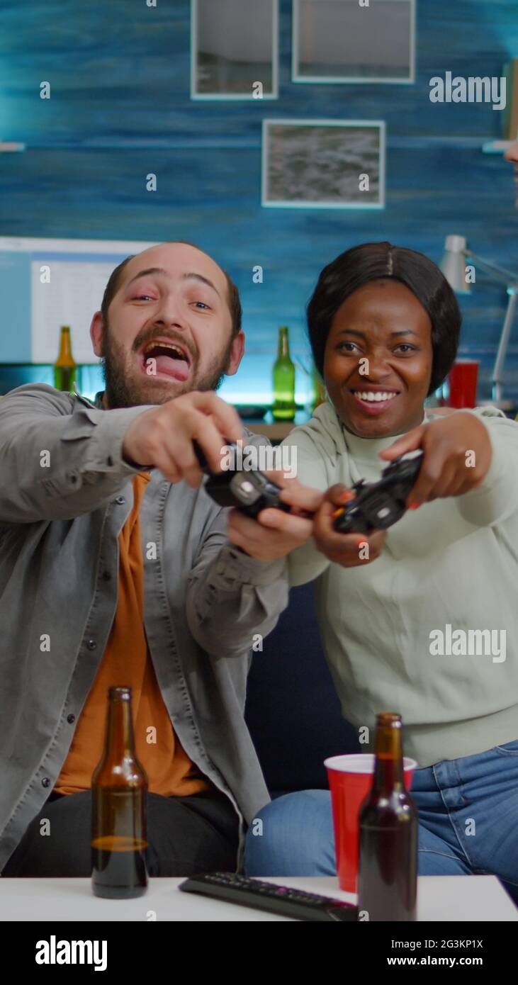 Two women losing online videogames using joystick playing for gaming ...