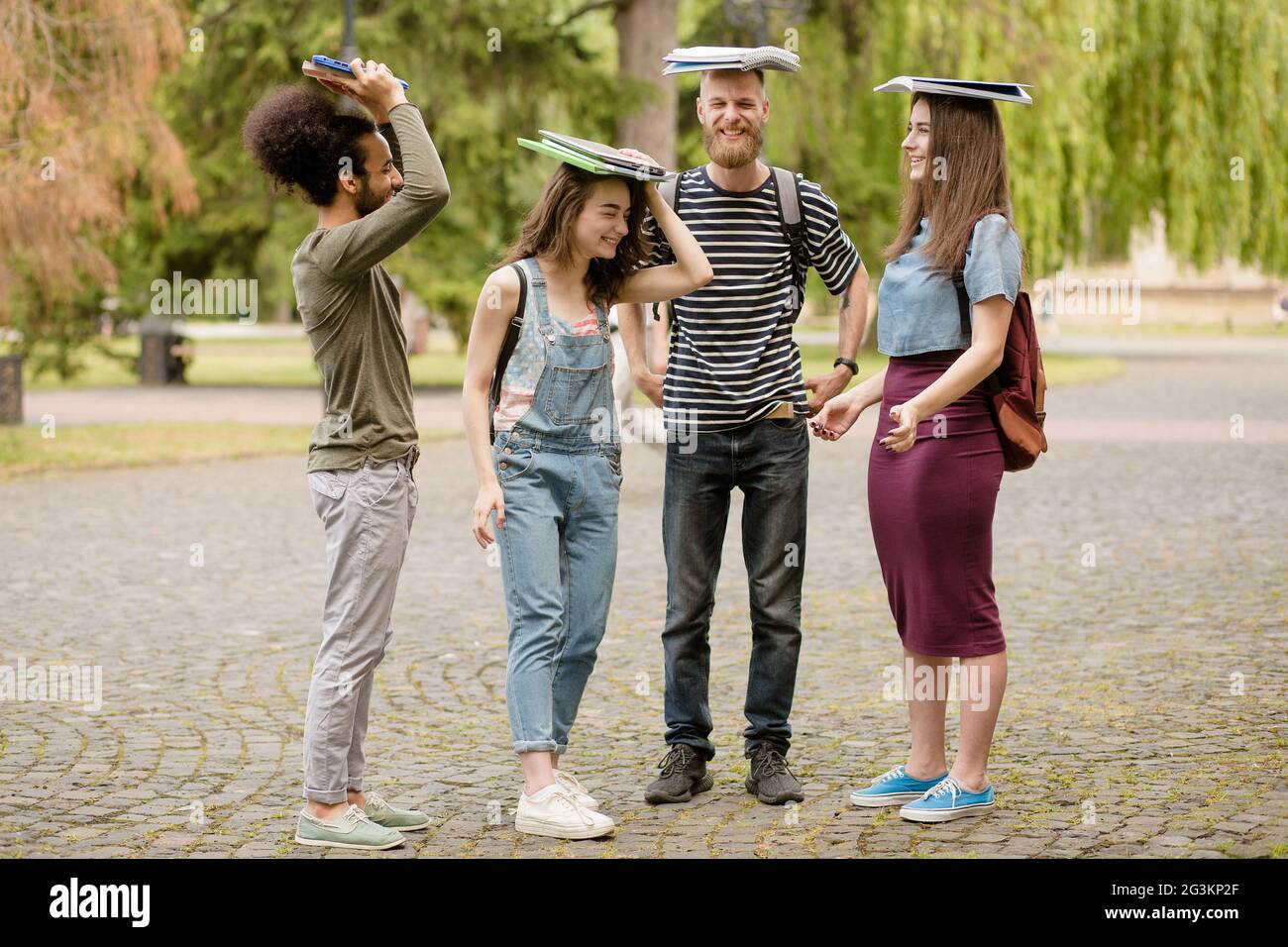 Full length view on students walking in campus, fooling around Stock ...