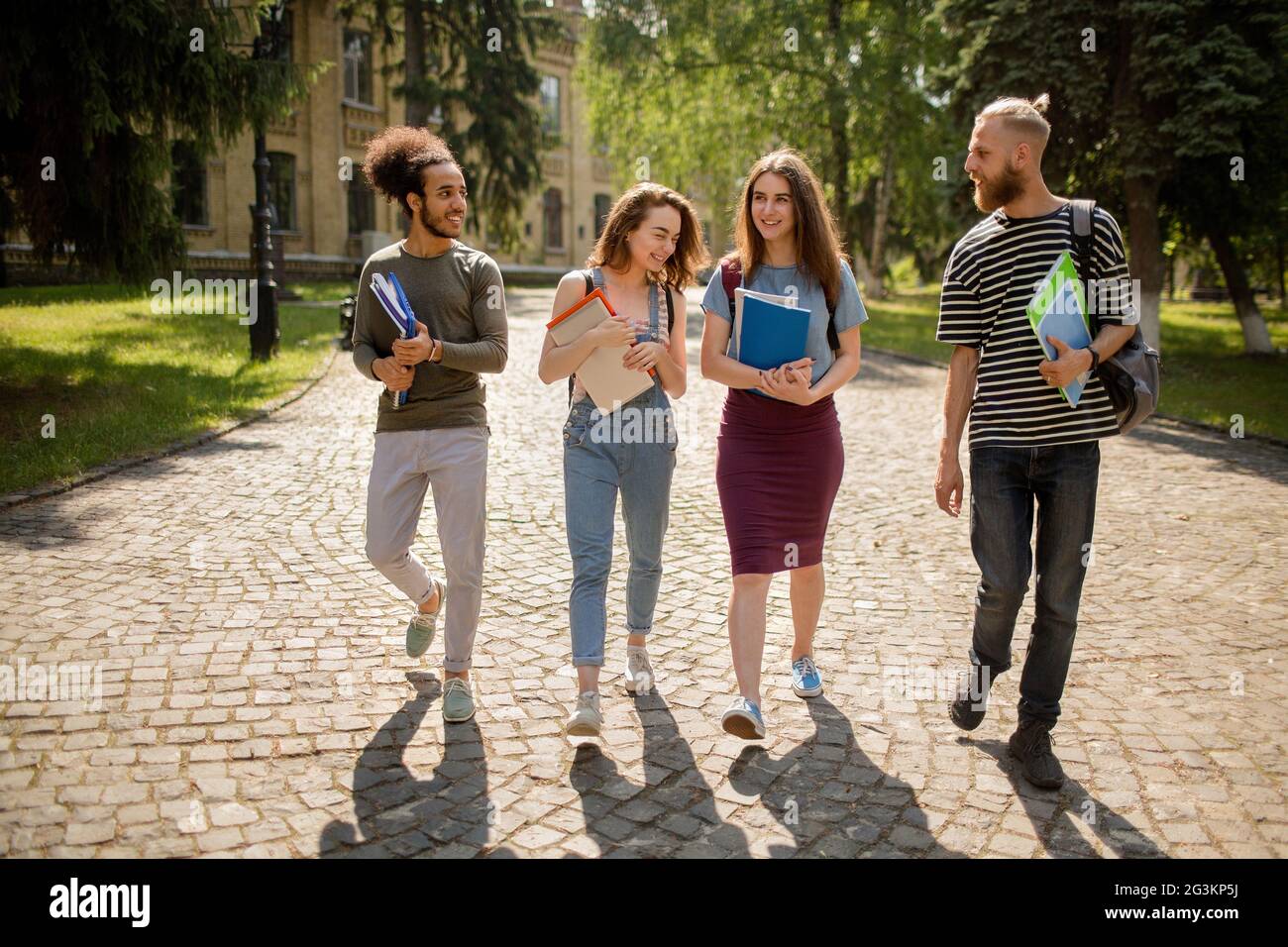 Sunny day campus students walking Stock Photo - Alamy