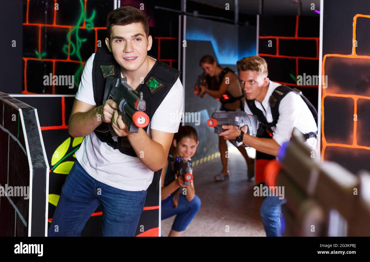men and women playing emotionally laser tag game in arena Stock Photo ...