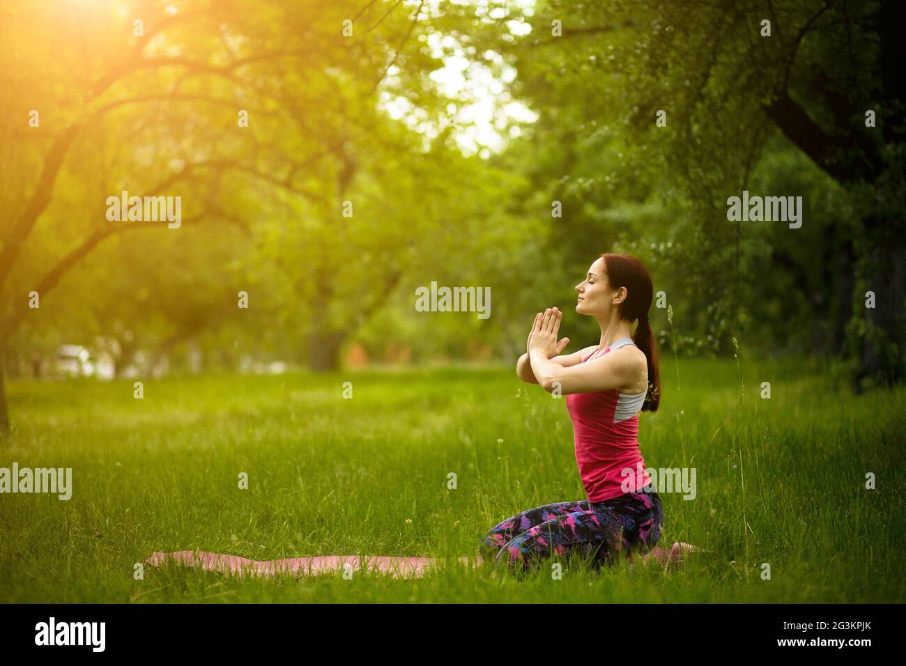Young female in morning garden practicing yoga in diamond pose Stock ...
