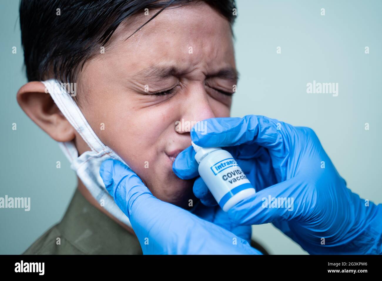 Head shot of child with medical face mask getting Intranasal Coronvirus ...