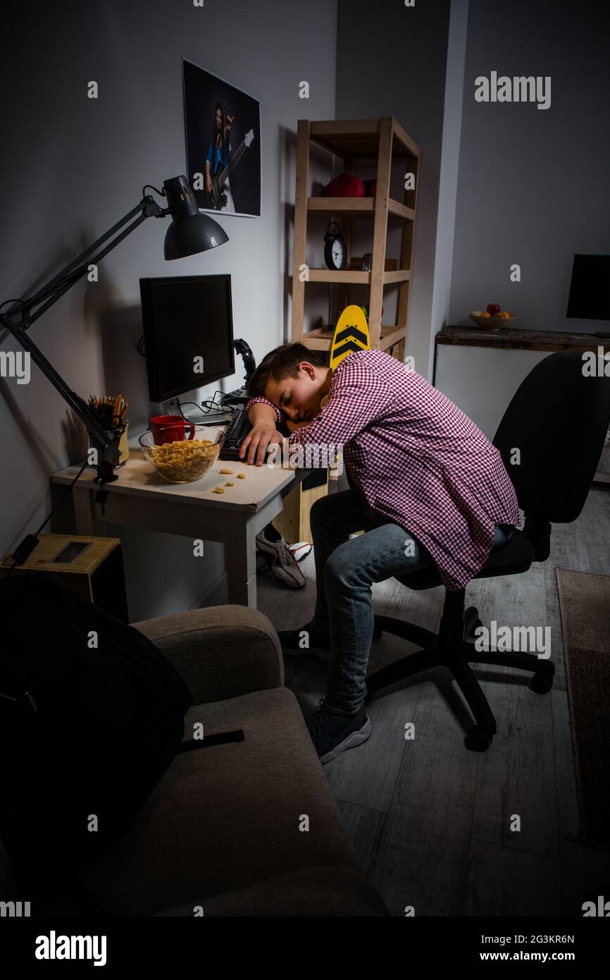 Teenage boy sleeping in front of computer Stock Photo - Alamy