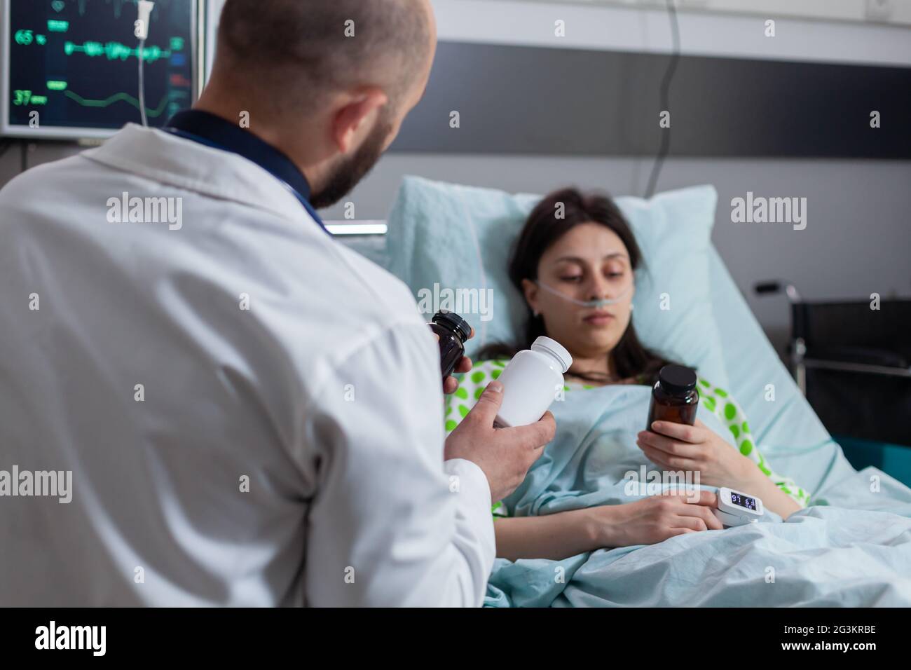 Physician medic monitoring sick patient during medical appointment in ...