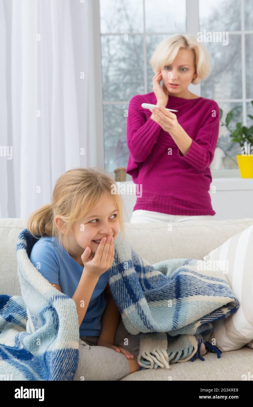Concerned mother checking daughter hi-res stock photography and images ...