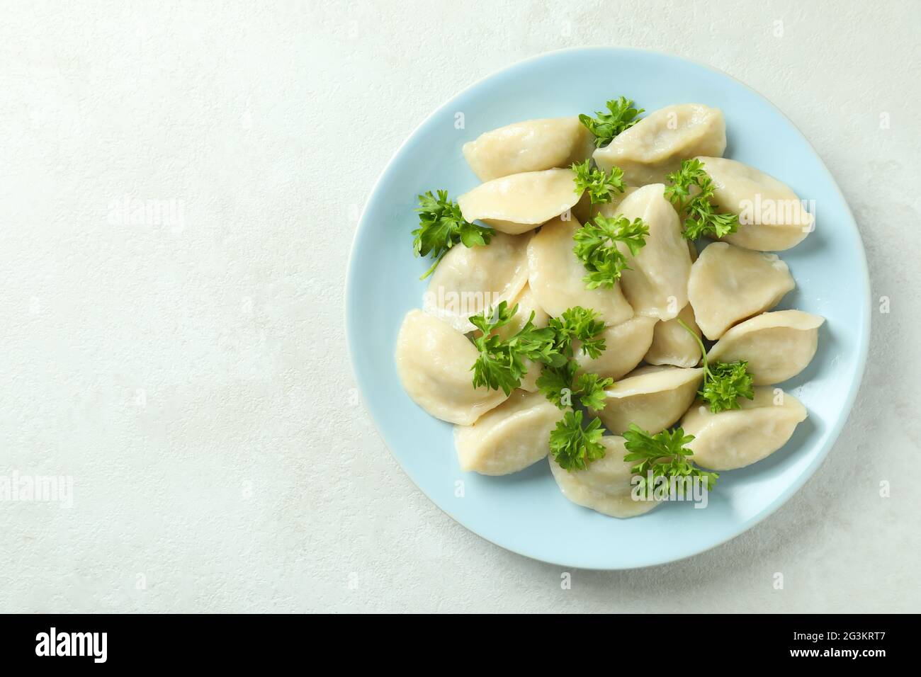 Concept of tasty food with vareniki or pierogi on white textured table ...
