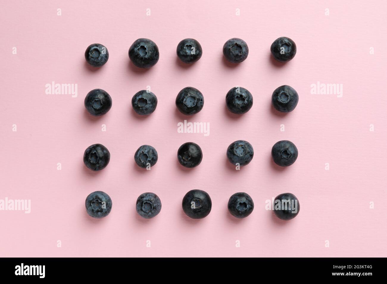 Fresh berry concept with blueberry on pink background Stock Photo - Alamy