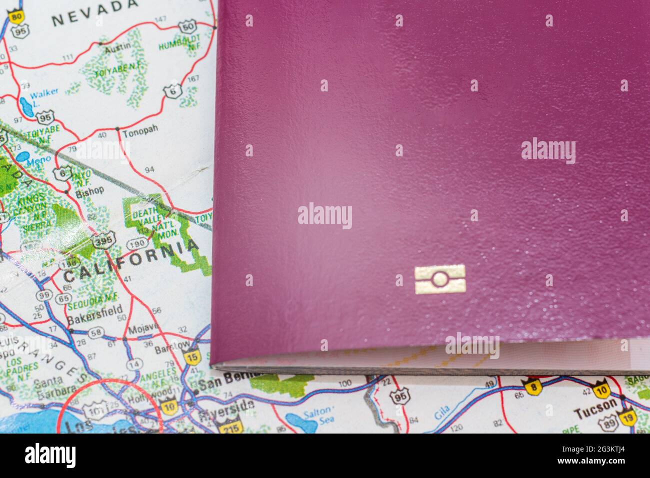 Red passport over map. Focus on the California North American continent ...