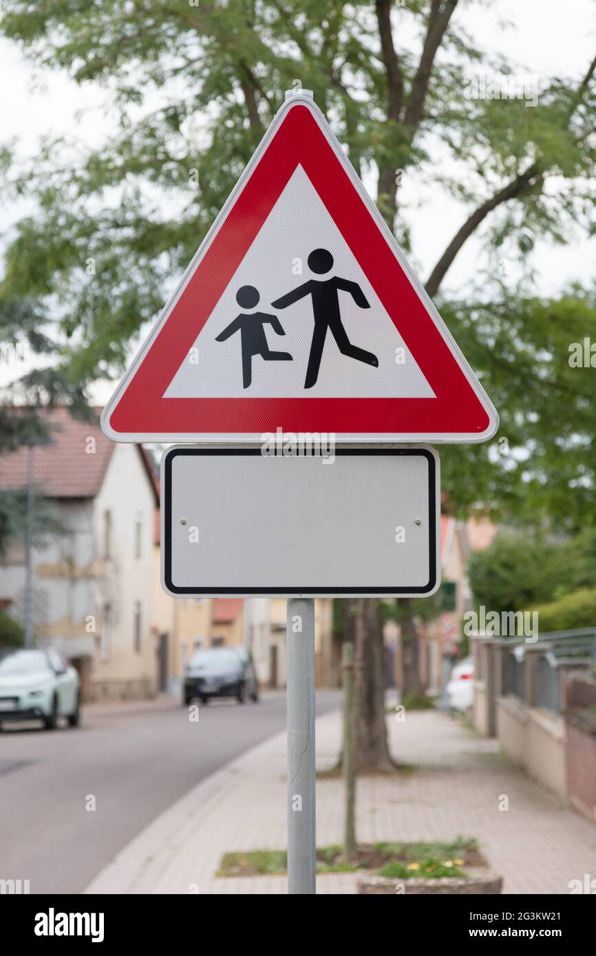 Attention children roadsign Stock Photo - Alamy