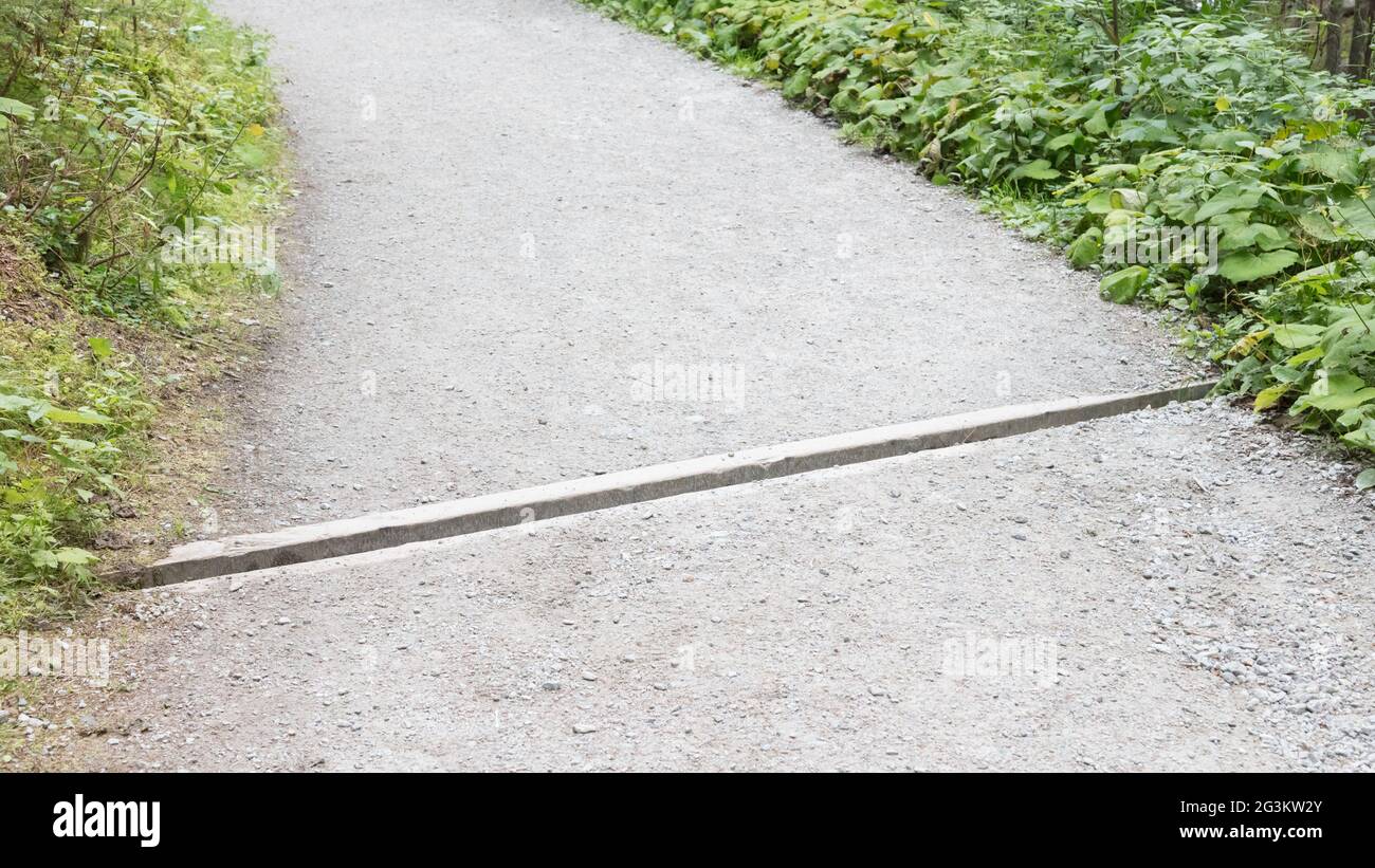 Wooden storm rain drainage on a path in the mountains Stock Photo - Alamy