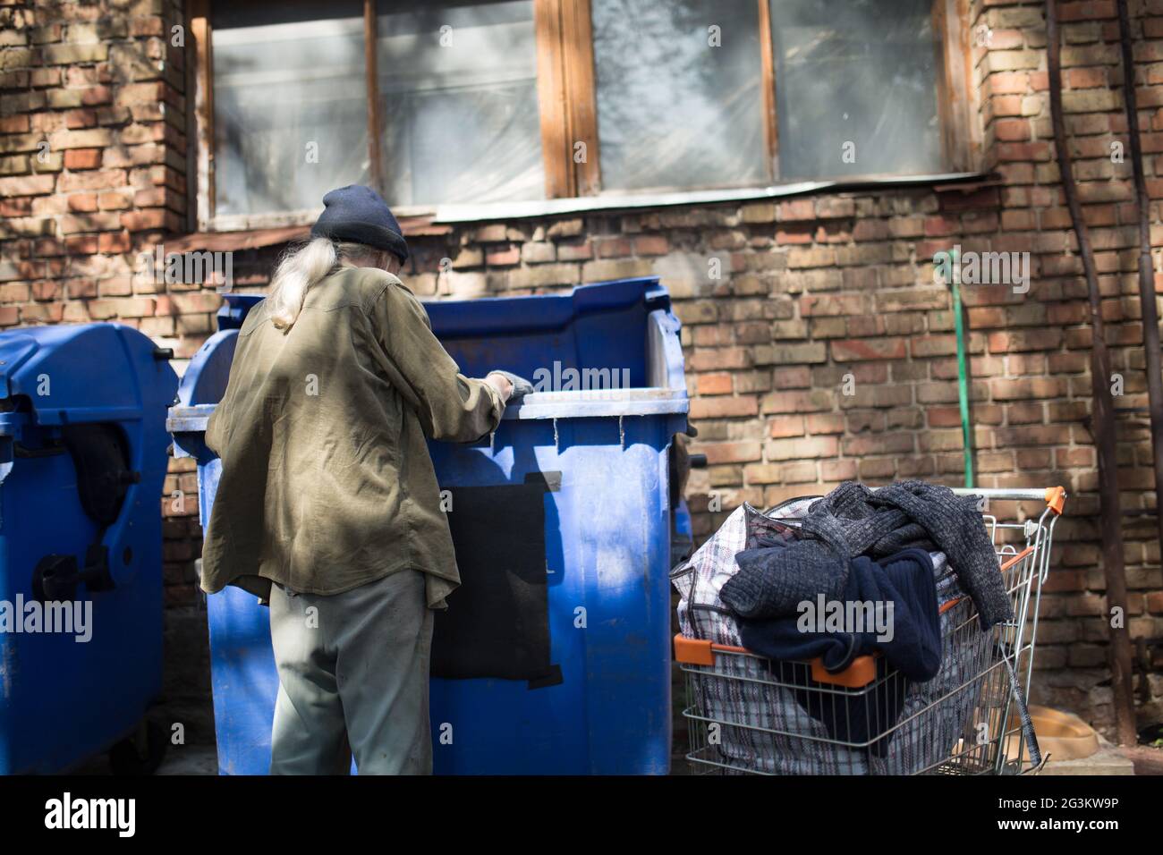 Poor old tramp in search for food or empty bottles Stock Photo - Alamy