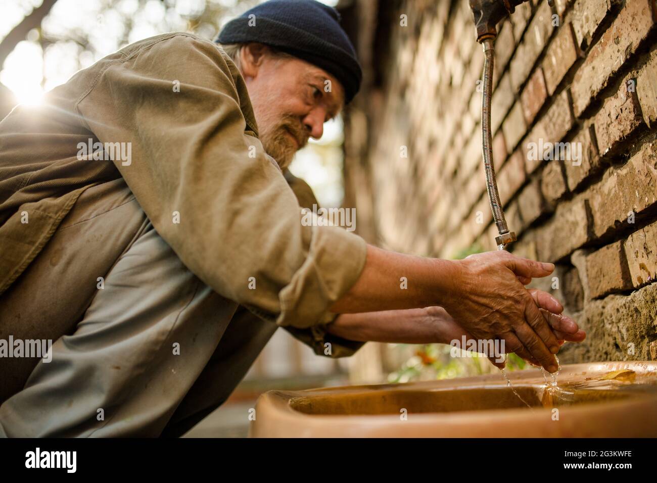 Close up view of homeless man washing hand in the street Stock Photo ...