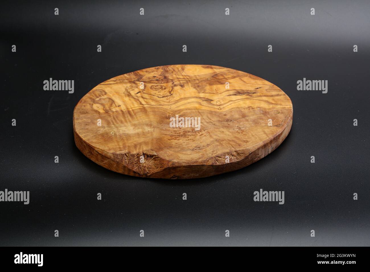 Olive tree board for kitchen over black background Stock Photo - Alamy