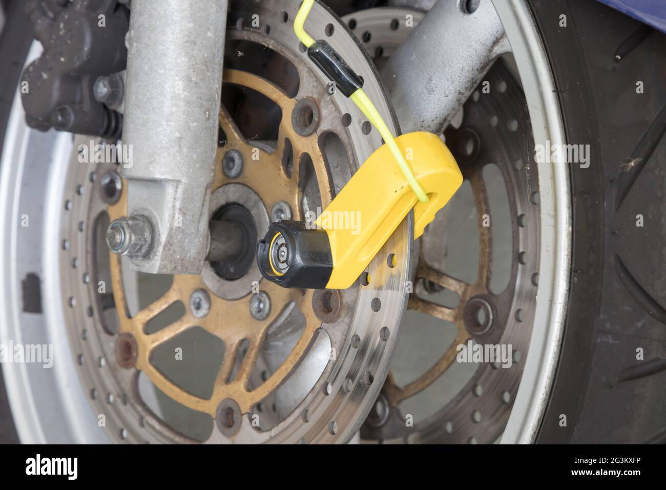 Security lock blocking the motorcycle wheel Stock Photo - Alamy