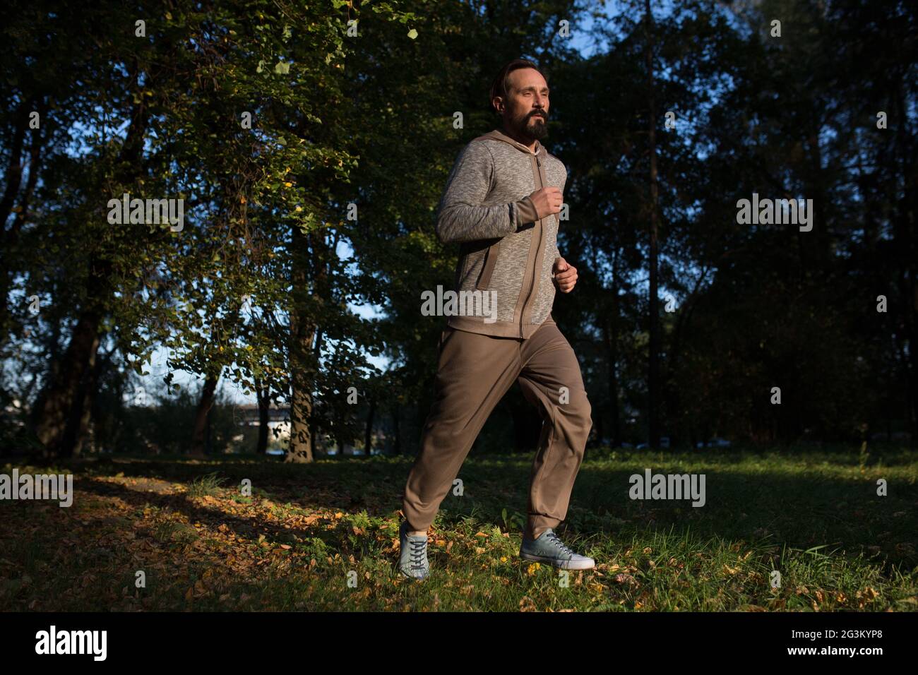 Adult man running in the park Stock Photo - Alamy