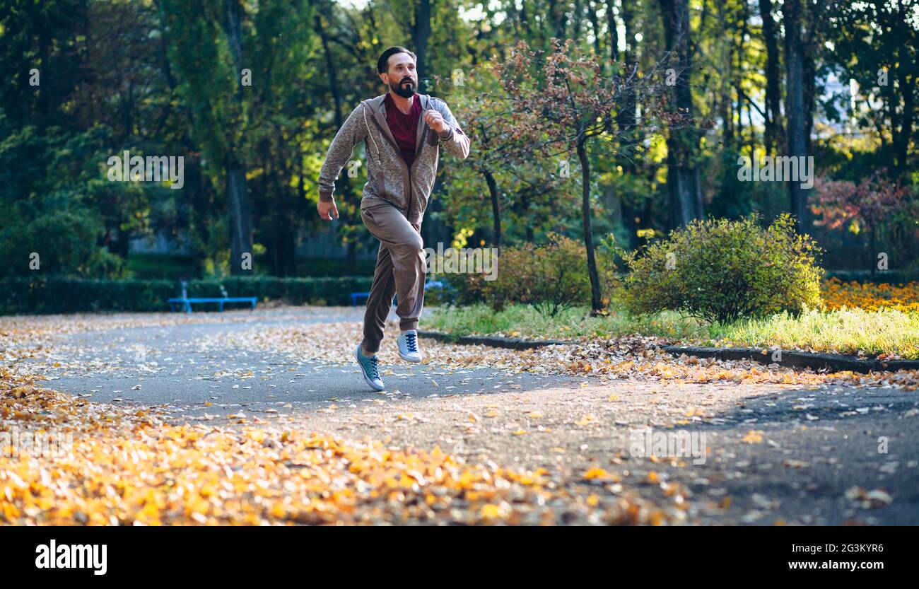 Healthy active man running in the park Stock Photo - Alamy