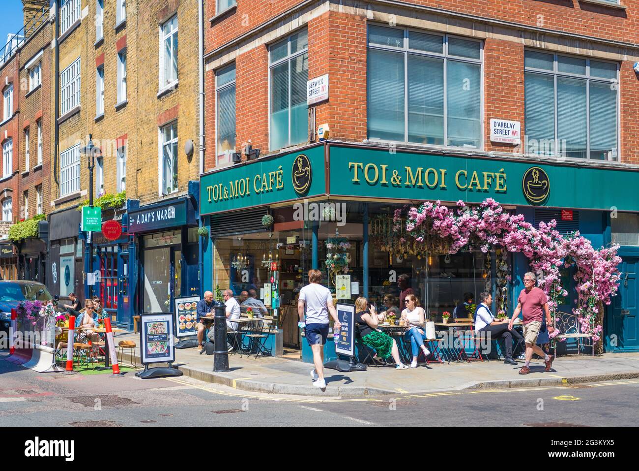 People seated at pavement tables outside the Toi & Moi Cafe coffee shop ...