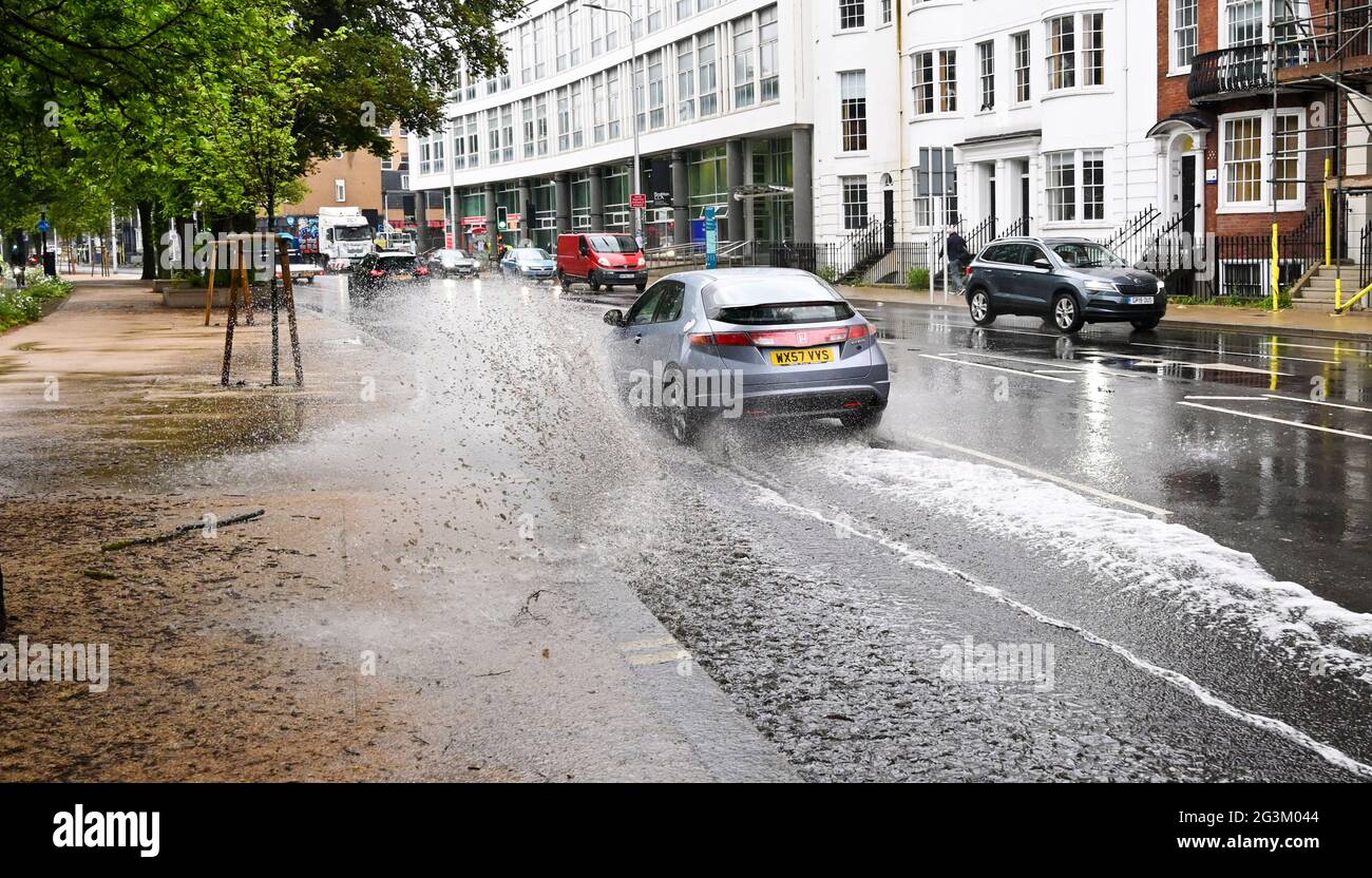 Brighton UK 17th June 2021 - Cars drive through floodwater on the roads ...