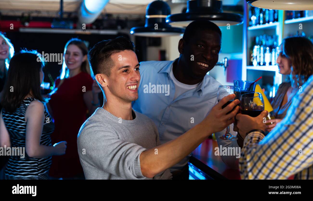 Group of male friends chatting in nightclub Stock Photo - Alamy
