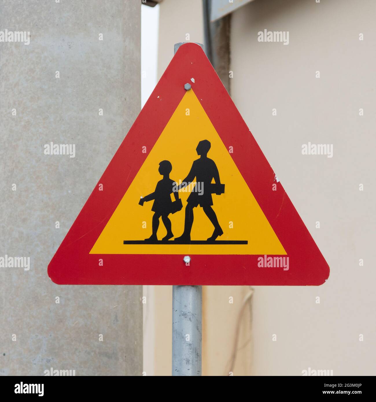 Warning sign of children crossing street from school Stock Photo - Alamy