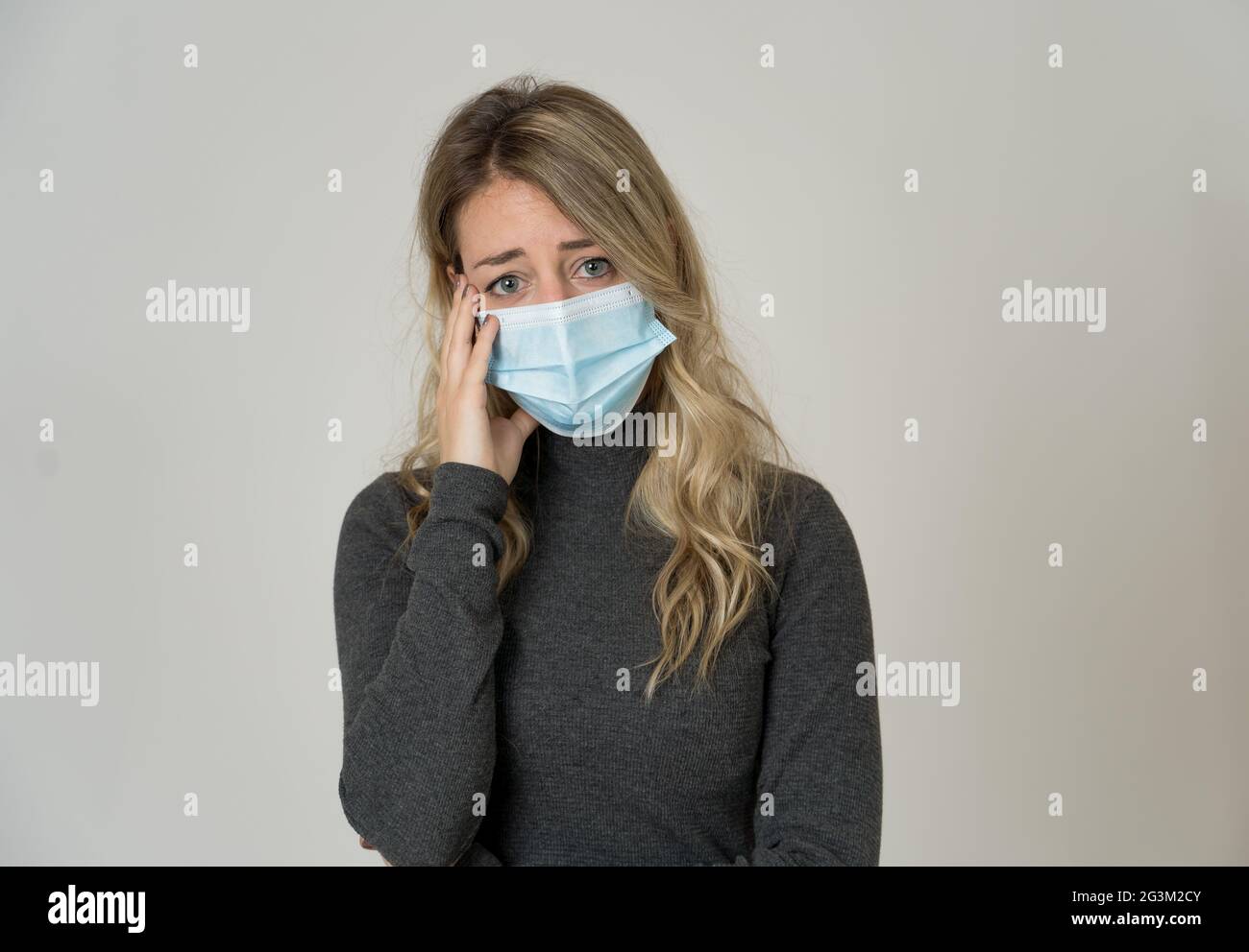 Sad depressed and worried woman with medical face mask feeling upset ...