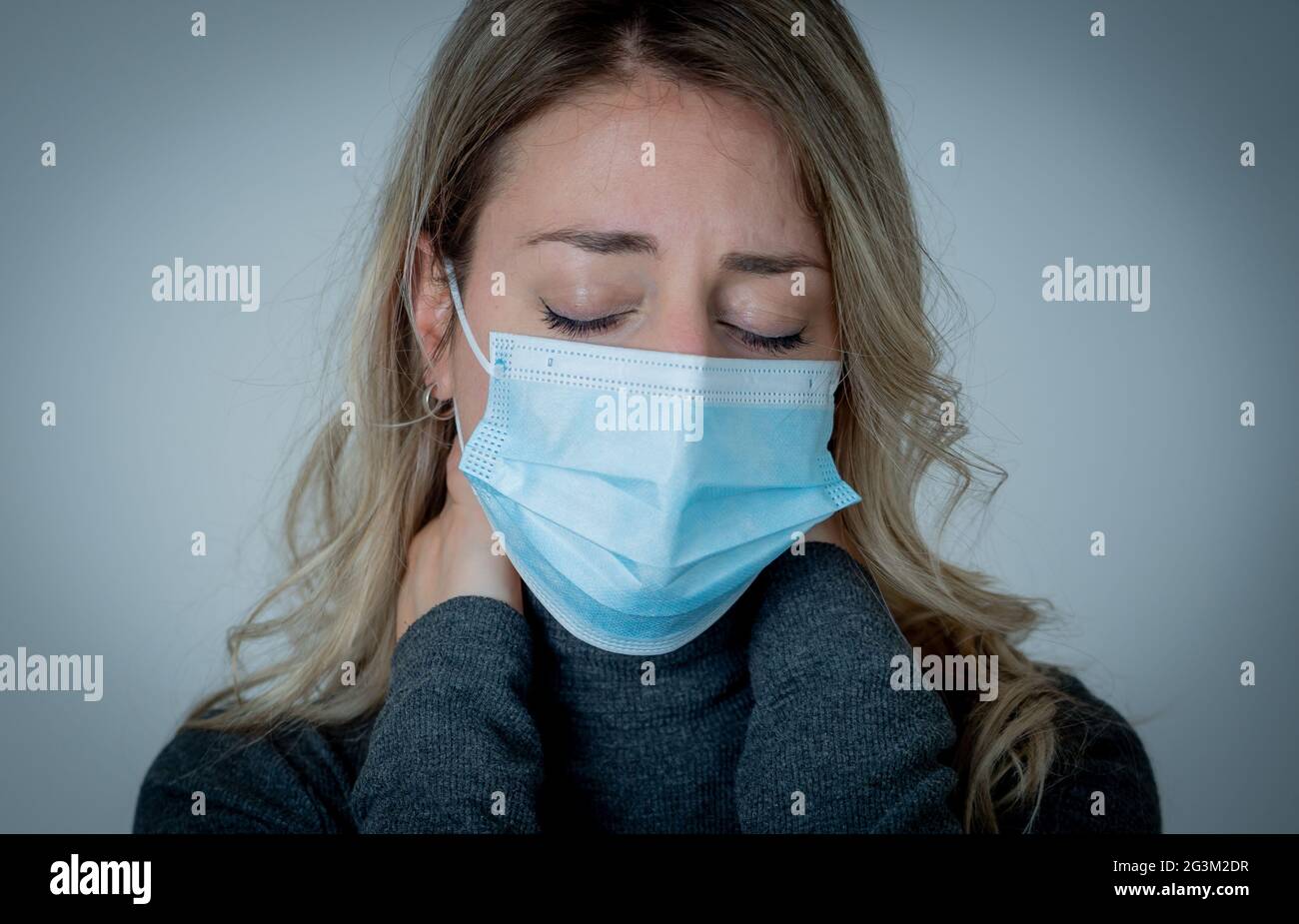 Sad depressed and worried woman with medical face mask feeling upset ...