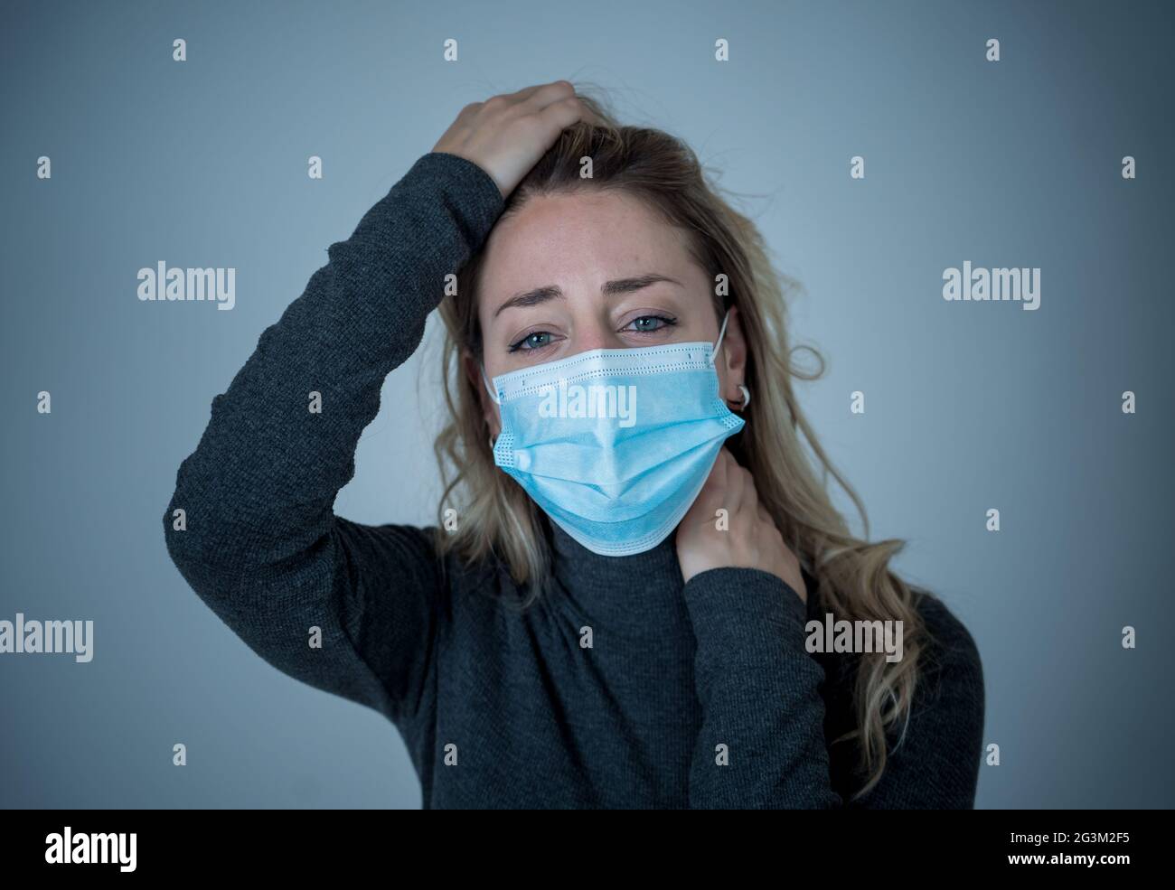 Sad depressed and worried woman with medical face mask feeling upset ...