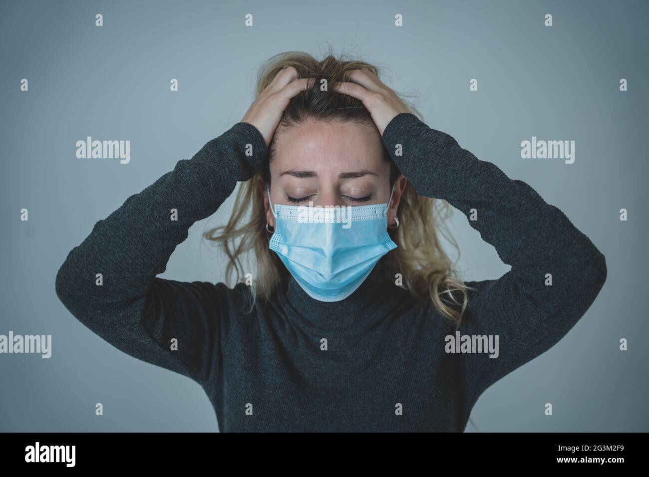 Sad depressed and worried woman with medical face mask feeling upset ...