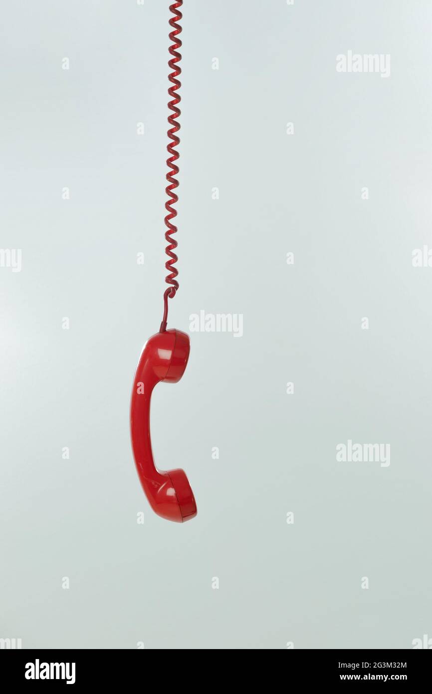 Vintage telephone hanging on a white background Stock Photo - Alamy