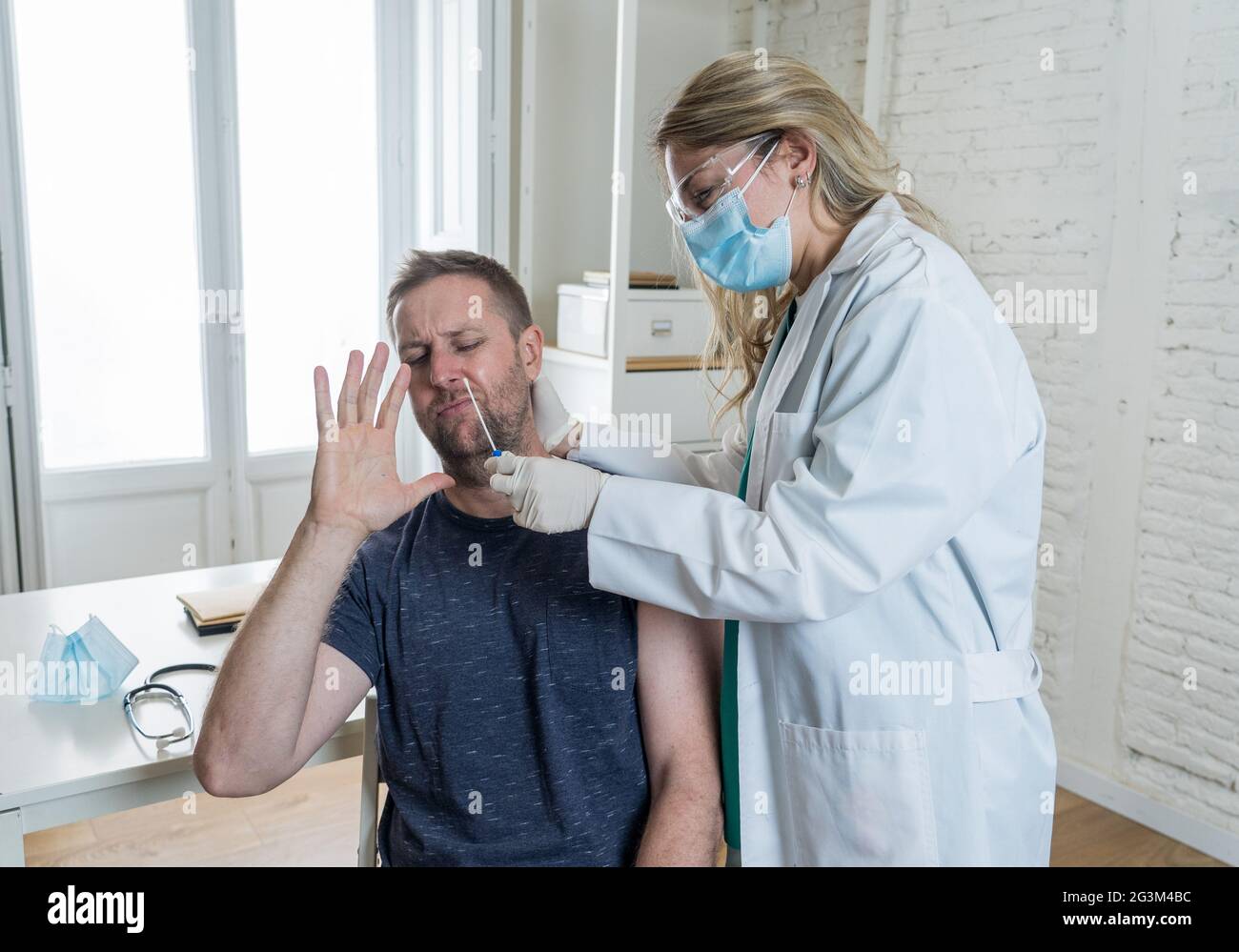 Nurse testing young adult man for coronavirus infection taking rapid ...