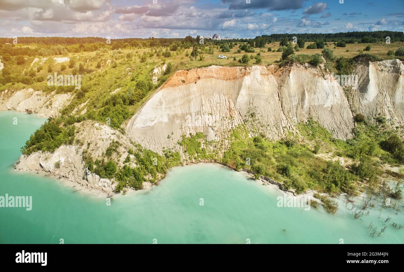Big cliff to green quarry water aerial drone view Stock Photo - Alamy