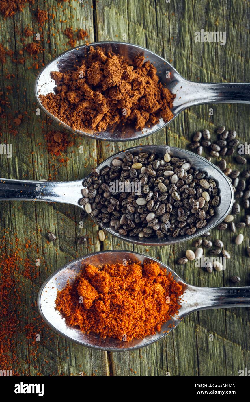 Spoons of cinnamon, cayenne peppers and chia seeds Stock Photo - Alamy