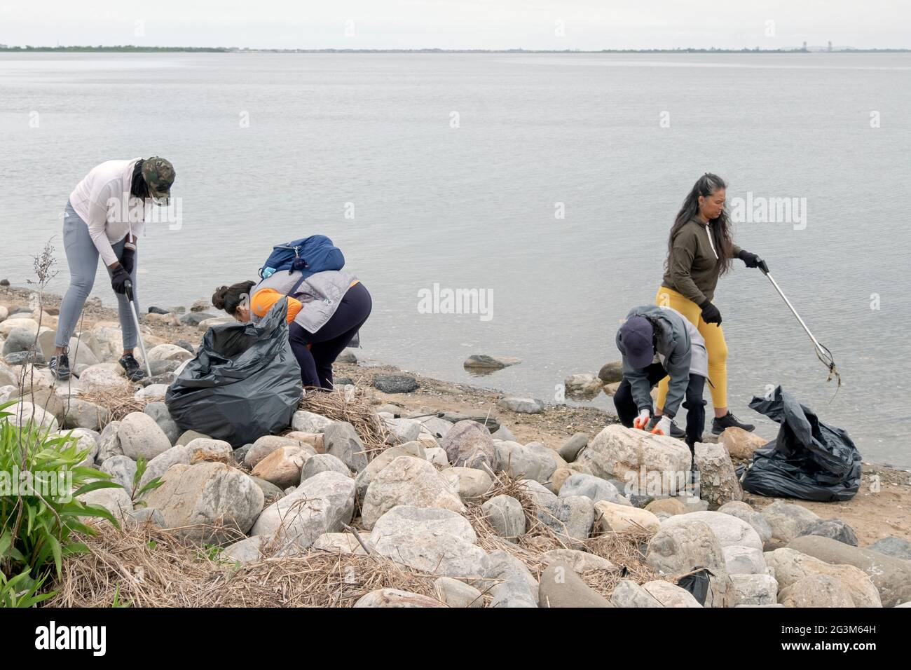 Volunteers clean the beach at Jamaica Bay in Queens as part of the 2021 ...
