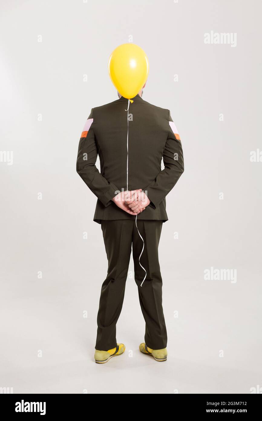 Happy man with yellow balloon Stock Photo - Alamy
