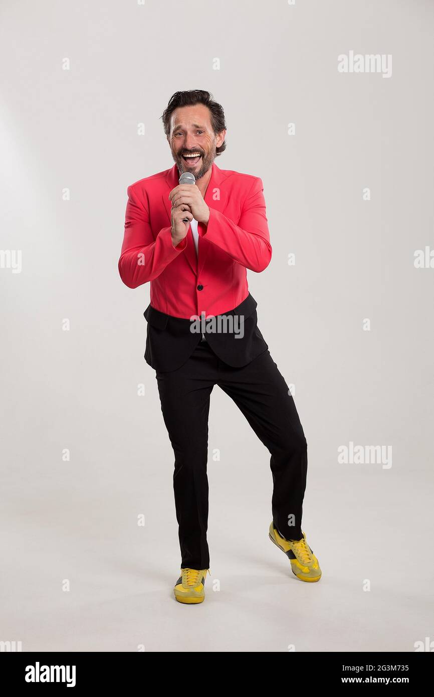Handsome man in red and black suit Stock Photo - Alamy