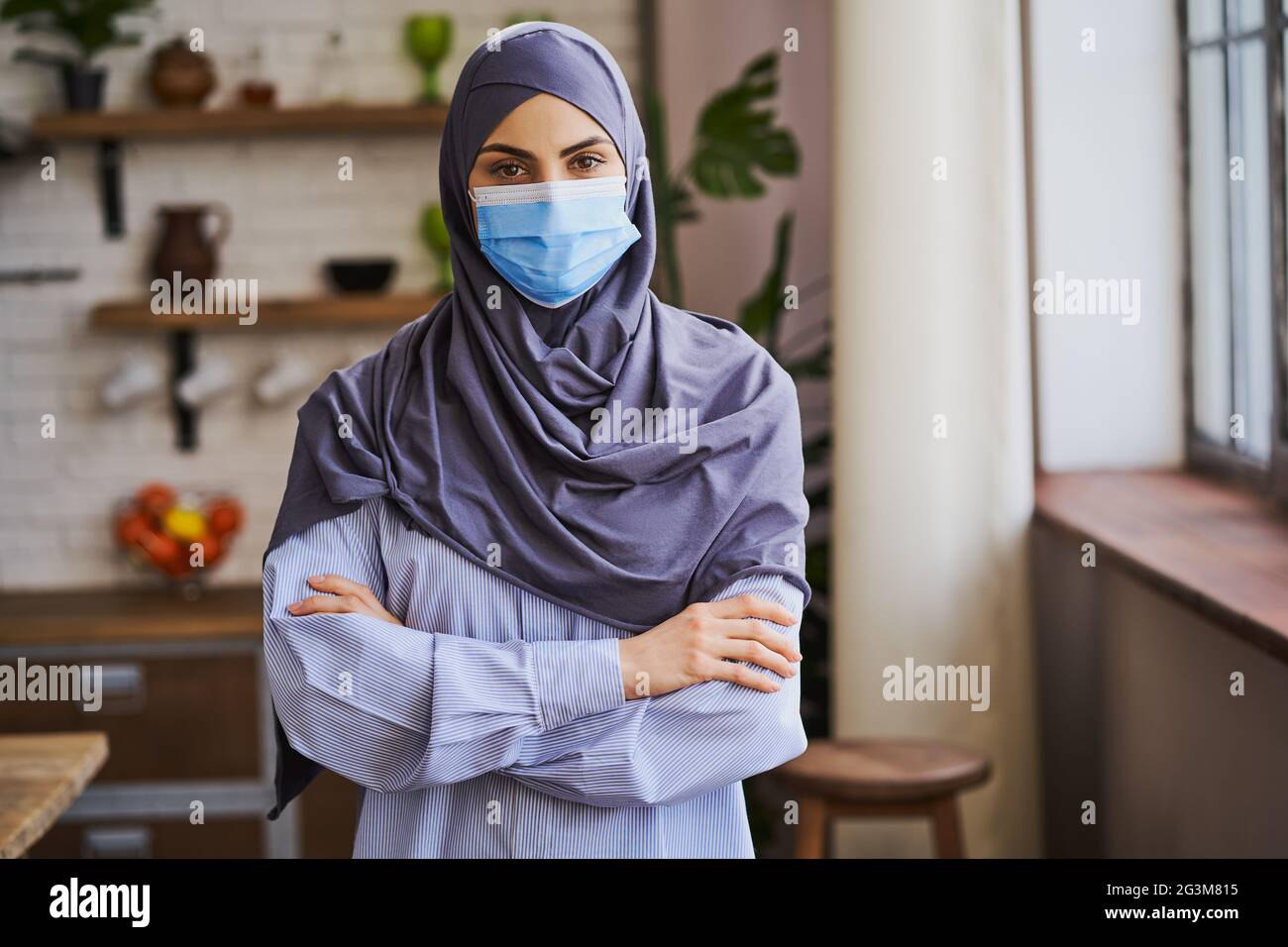 Arabian woman wearing hijab, face mask and holding arms crossed Stock ...
