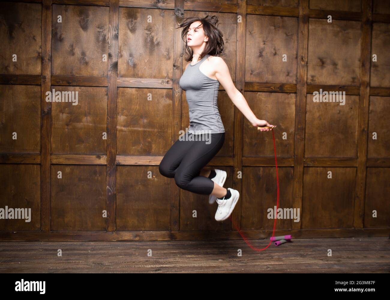 Girl jumping on skipping rope Stock Photo - Alamy