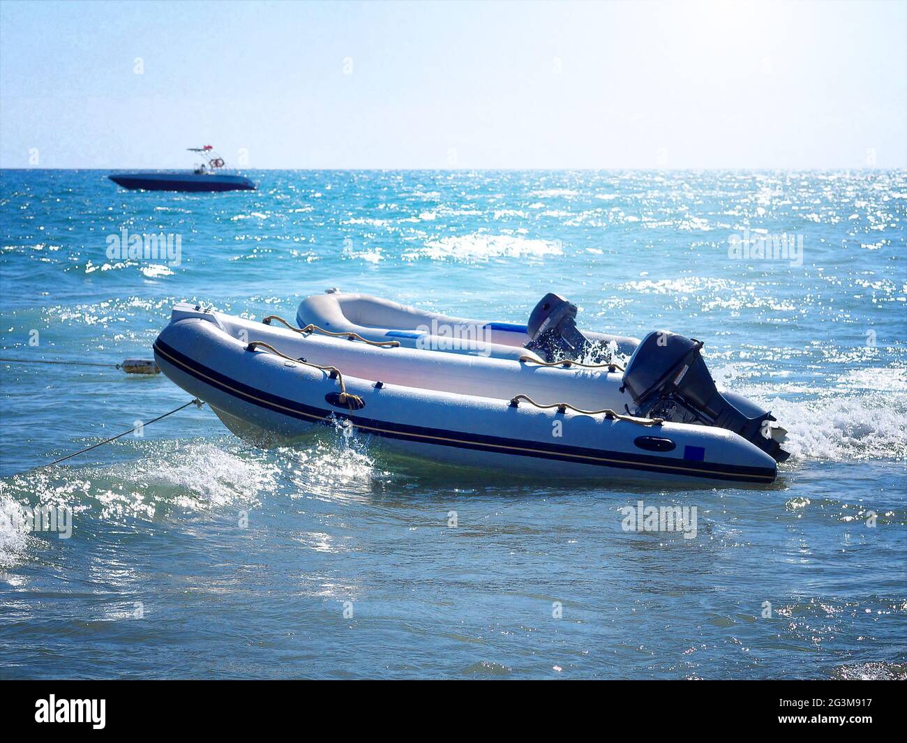 two inflatable boats with motors on a water Stock Photo - Alamy